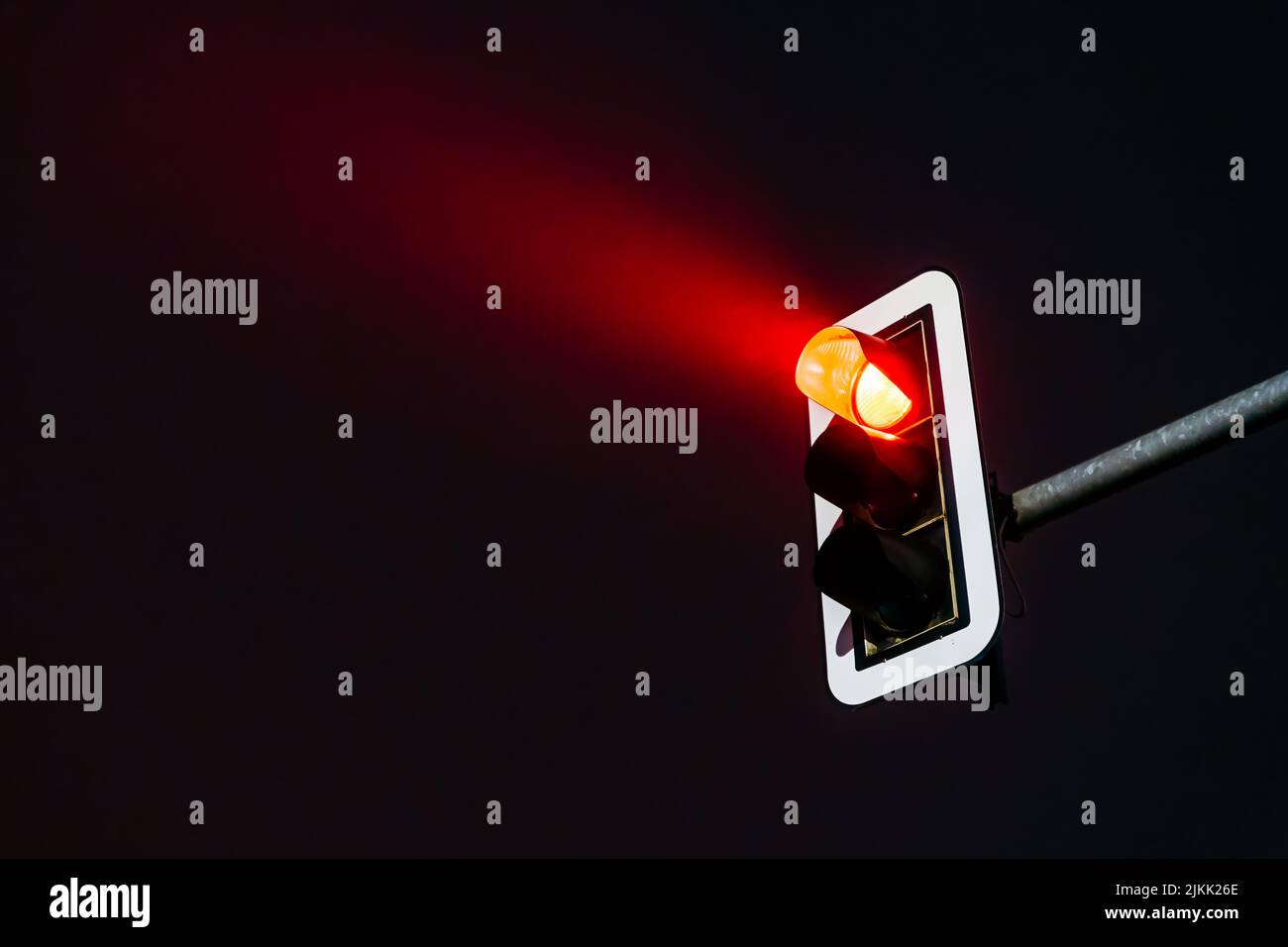 A low angle of a red traffic light in the foggy weather at night Stock ...