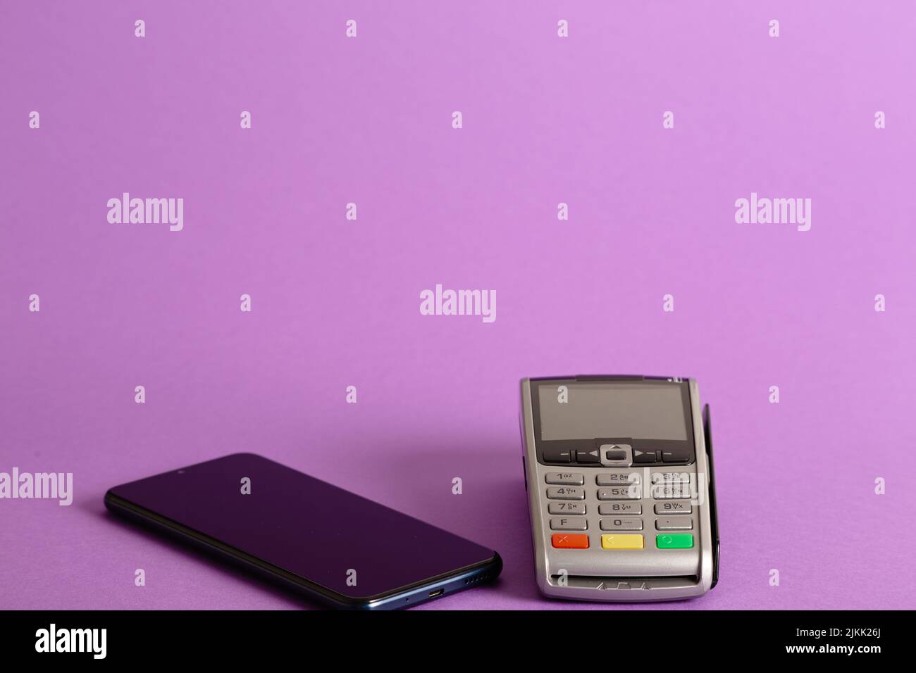 A closeup shot of the POS terminal credit card machine and a phone on a ...