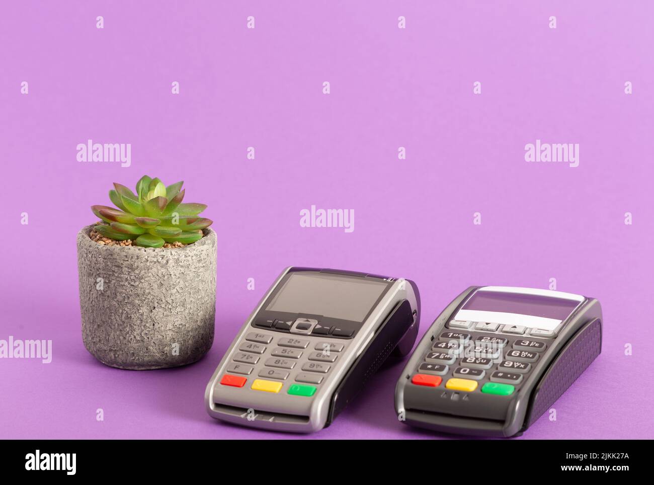 A closeup shot of the POS terminal credit card machines and plant on a ...