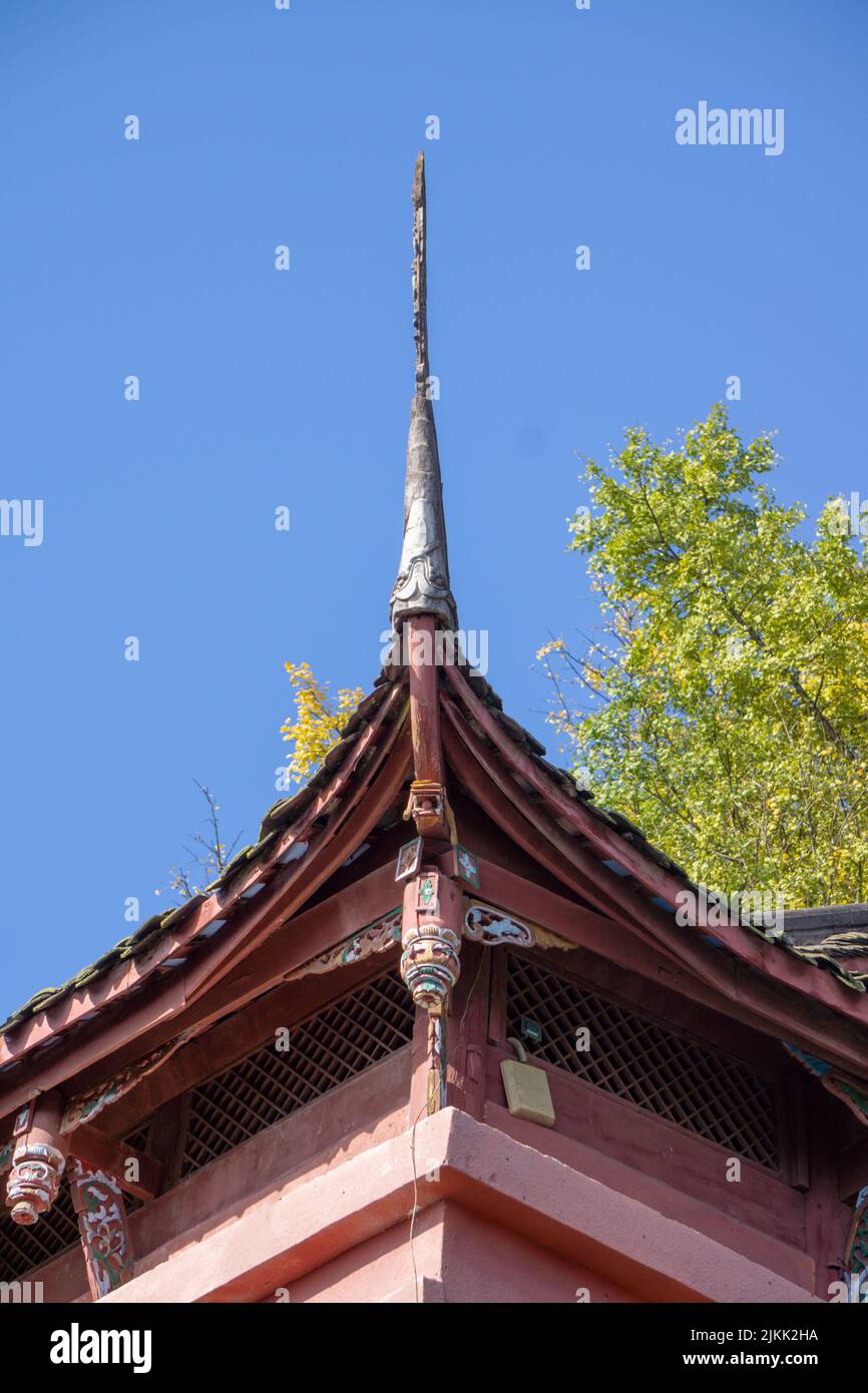 A sharp edge of a roof of an Asian style building on a sunny morning ...