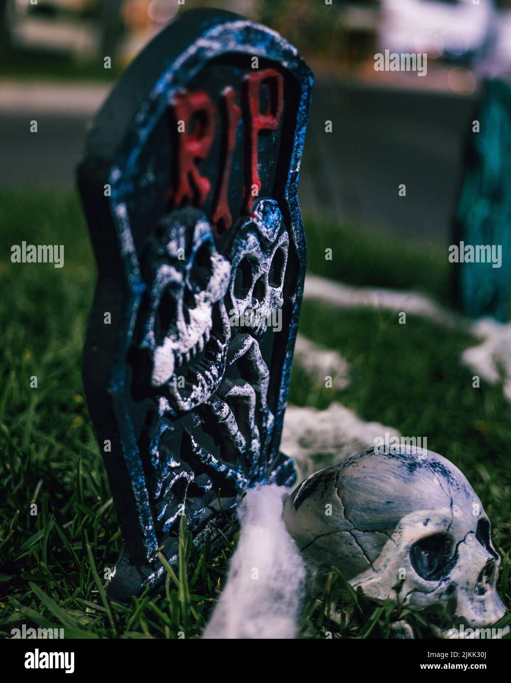 A shallow focus of a tombstone with a writing RIP and skulls Stock ...