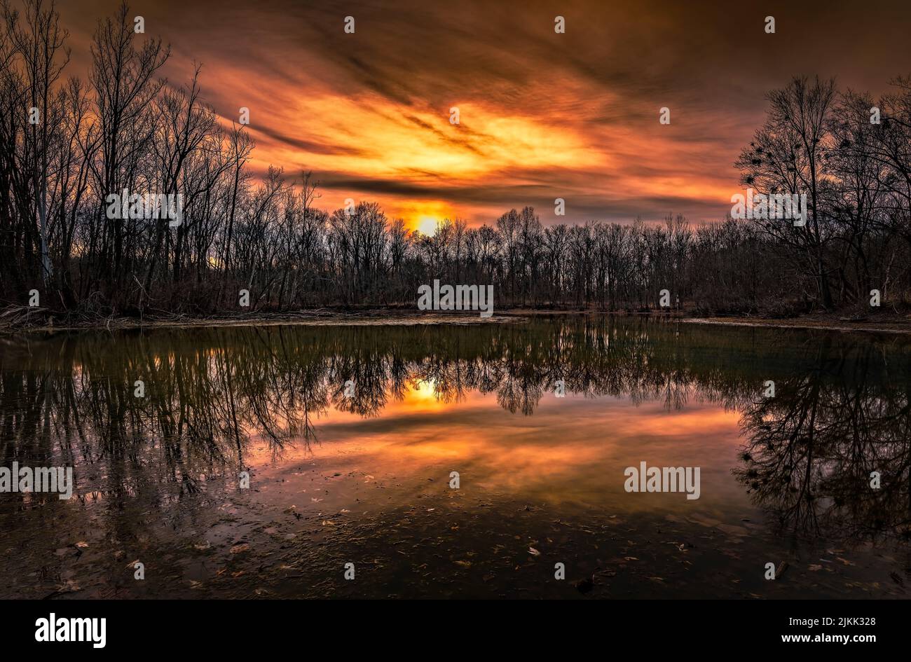A scenic view of the red sunset reflecting on the lake Stock Photo - Alamy