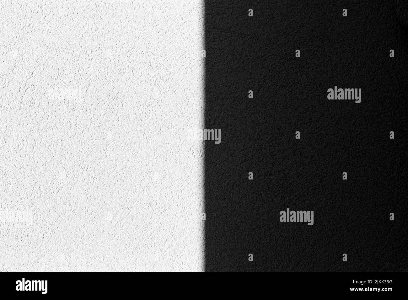 The equally split black and white wall texture Stock Photo - Alamy