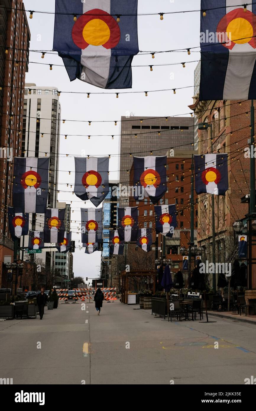 A vertical shot of downtown denver larimer with colorado flags Stock ...