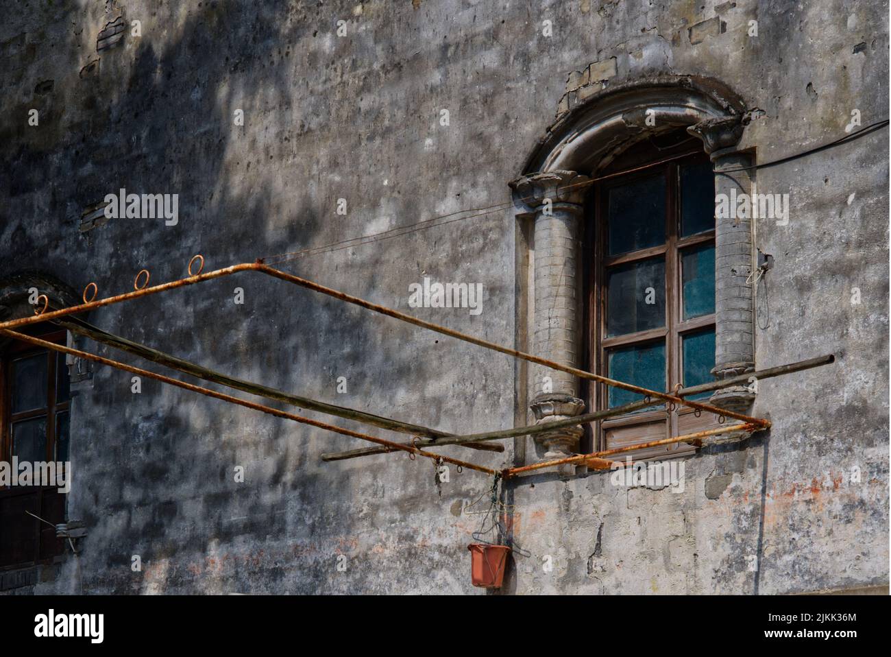 A low angle shot of a window of ancient building in the old village in ...