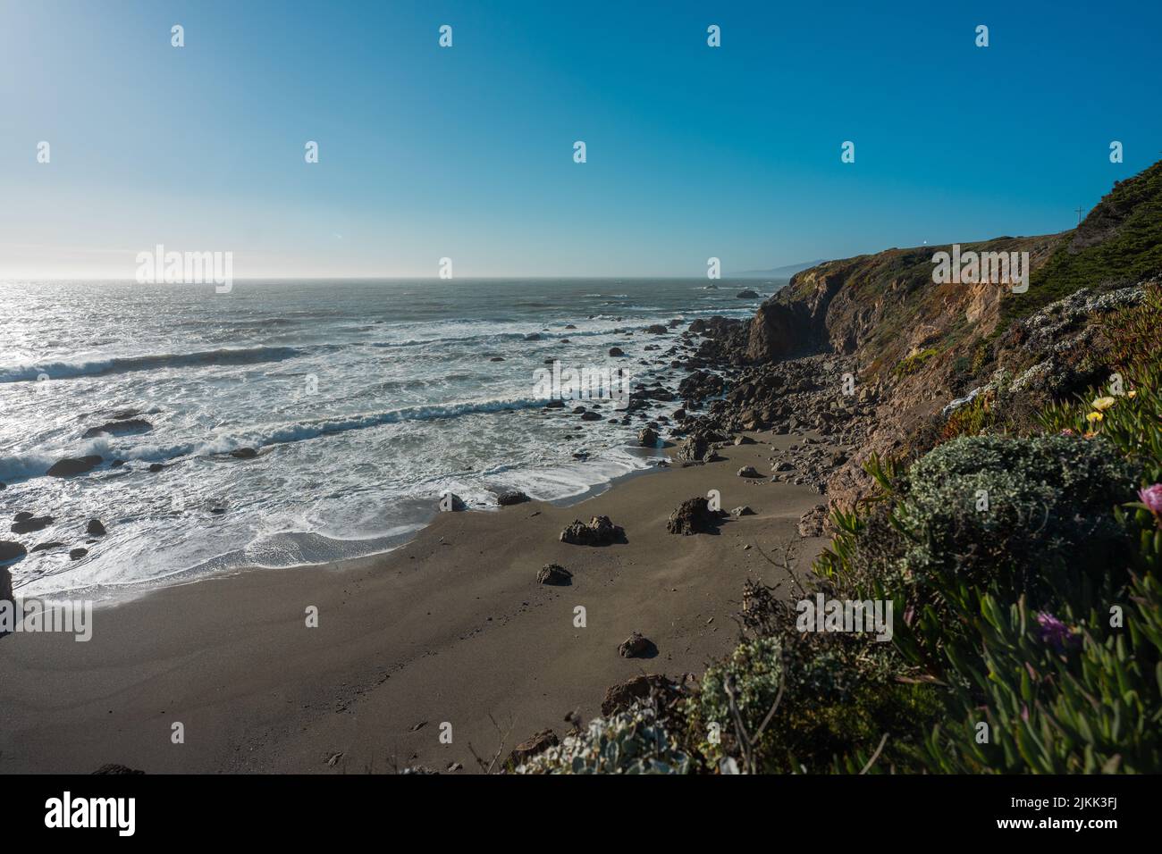 The blue sky over the sea captured from the sandy beach in Bodega Bay ...