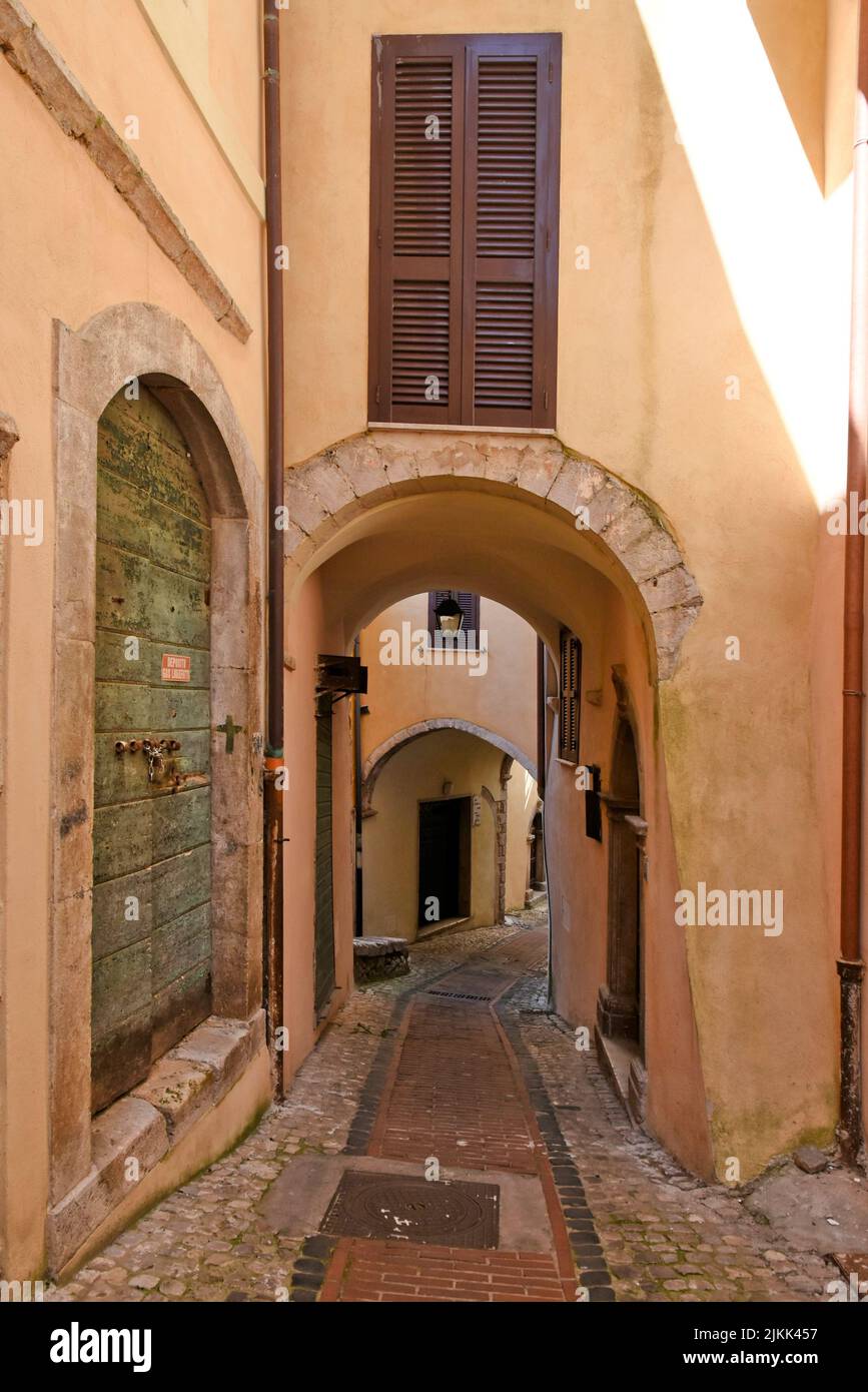 A street between old medieval stone buildings of a historic town in ...
