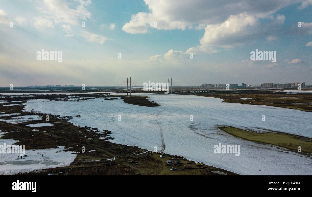 An aerial view of a winter landscape with city buildings in Harbin ...