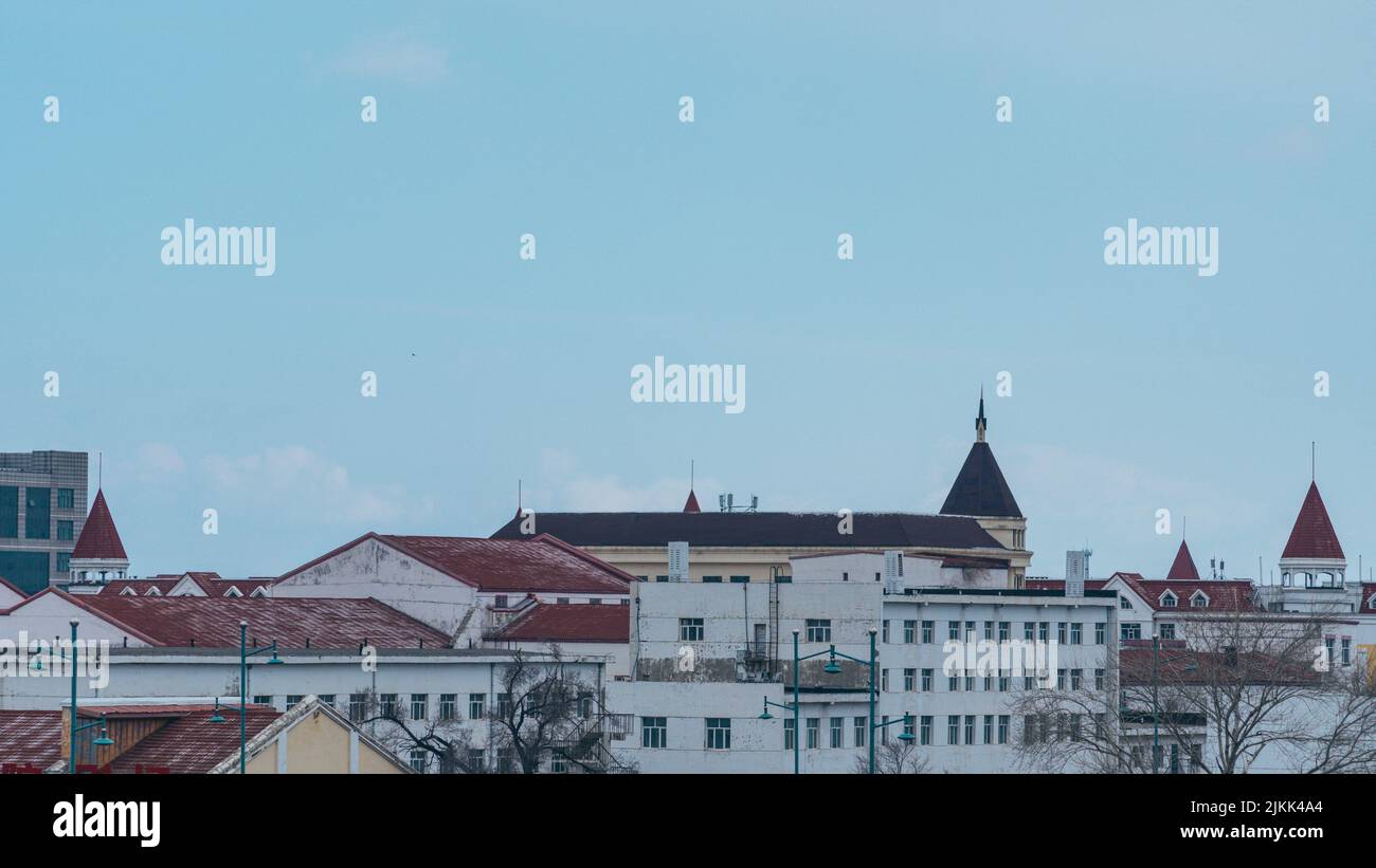 A series of rooftops in a traditional European city with a background ...