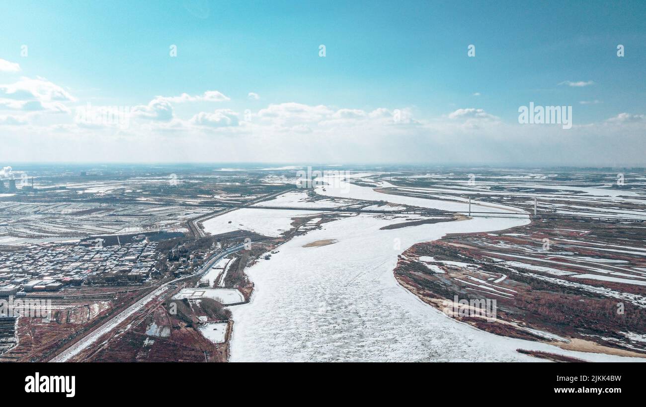 An aerial view of a winter landscape with city buildings in Harbin ...