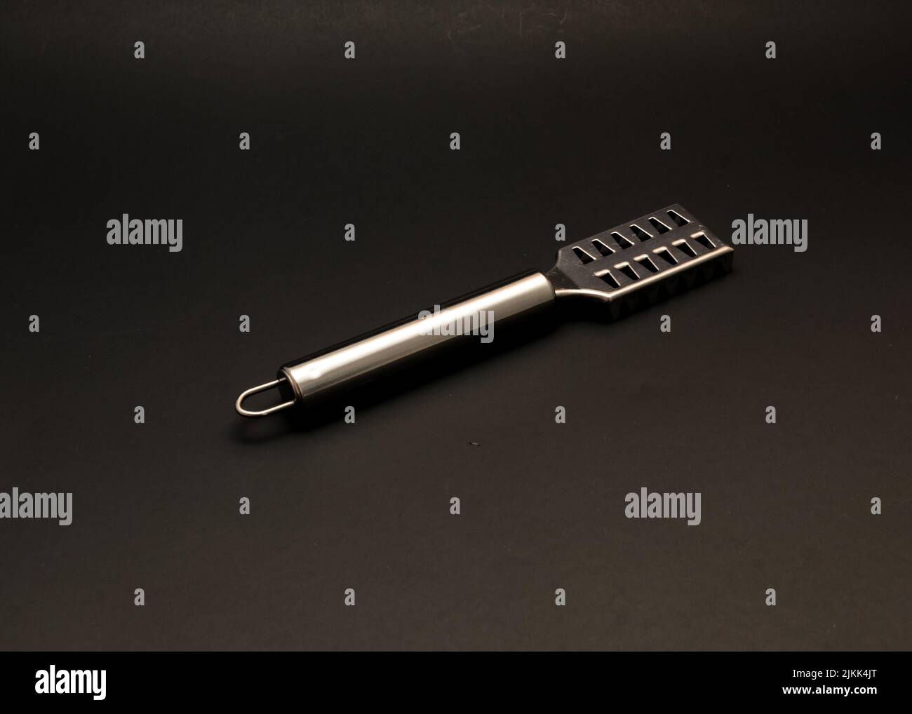 Top view single stainless steel fish scale scraper isolated on black ...