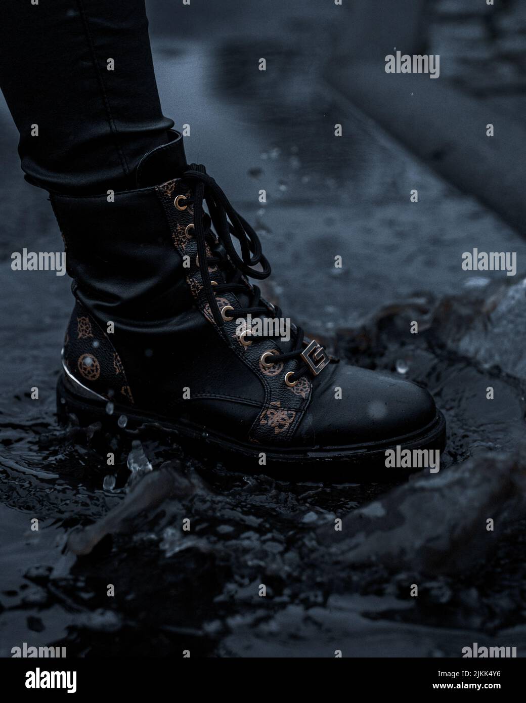 A vertical shot of a person stepping into a paddle in an elegant boot ...
