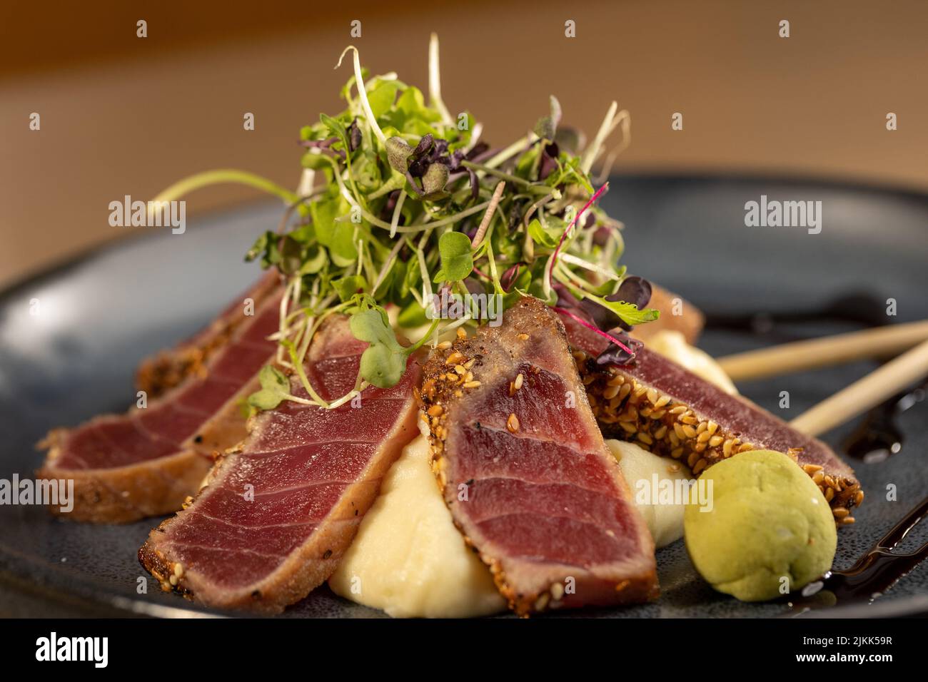 Yummy composition with fish tataki and greens Stock Photo - Alamy