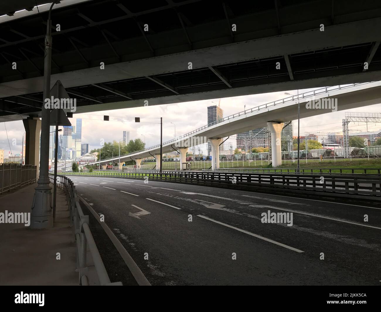 An asphalt road under an overpass Stock Photo - Alamy