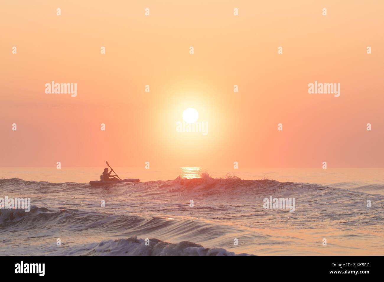A man on the sailing boat during sunset Stock Photo - Alamy