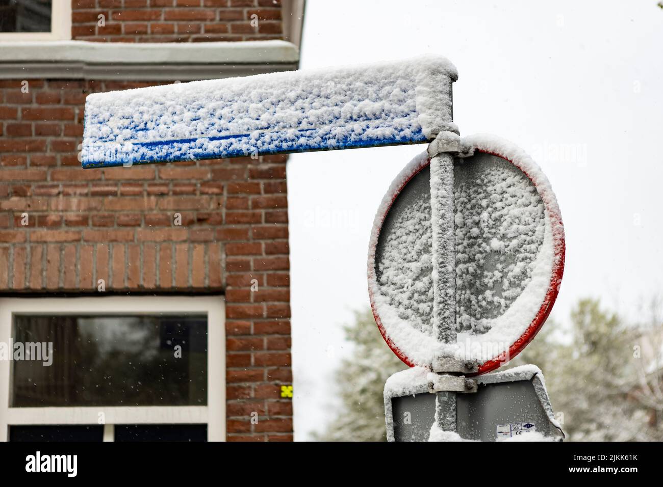Street signs covered in snow with name unintelligible. Dutch winter ...