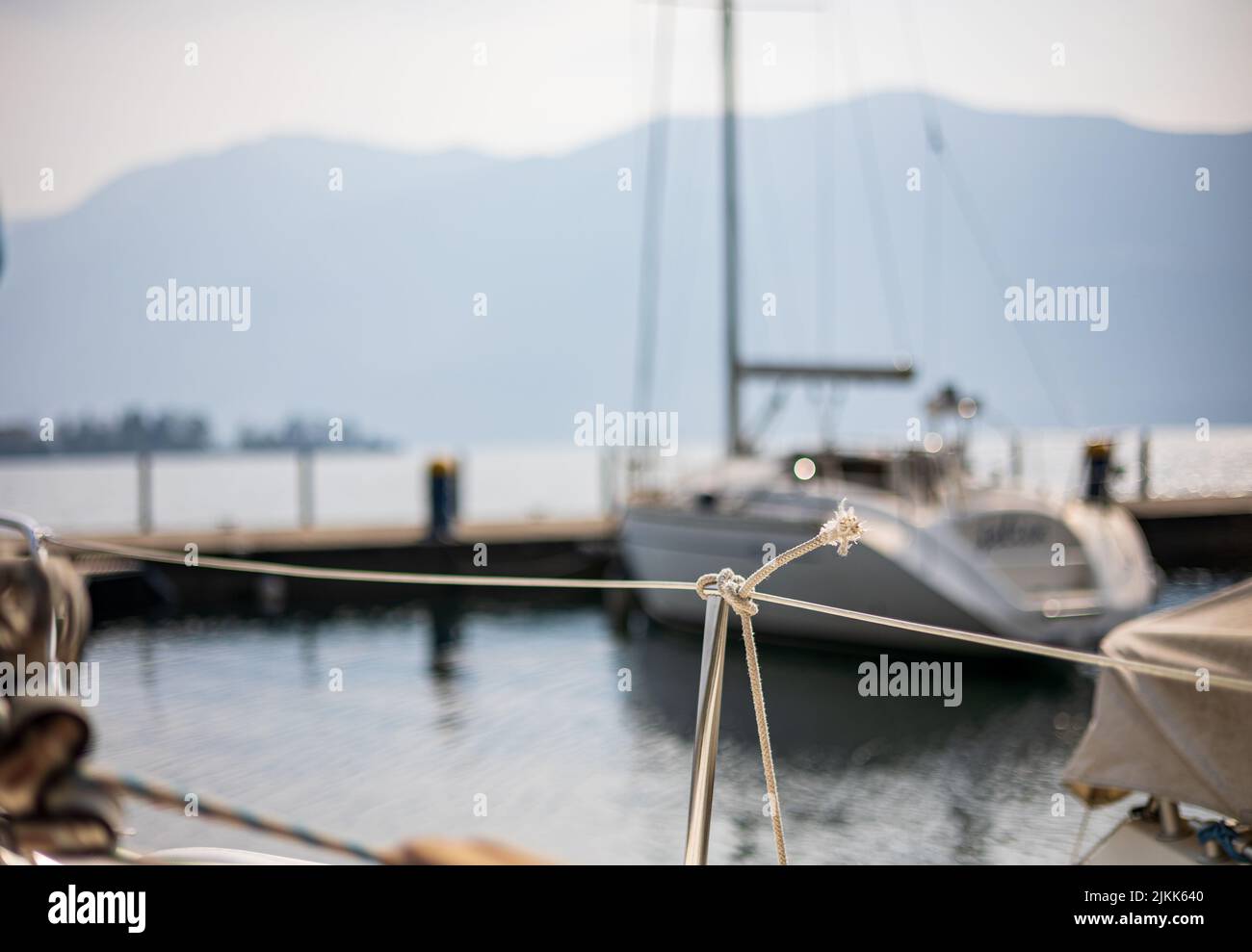 A closeup shot of ropes at a port with boats Stock Photo - Alamy