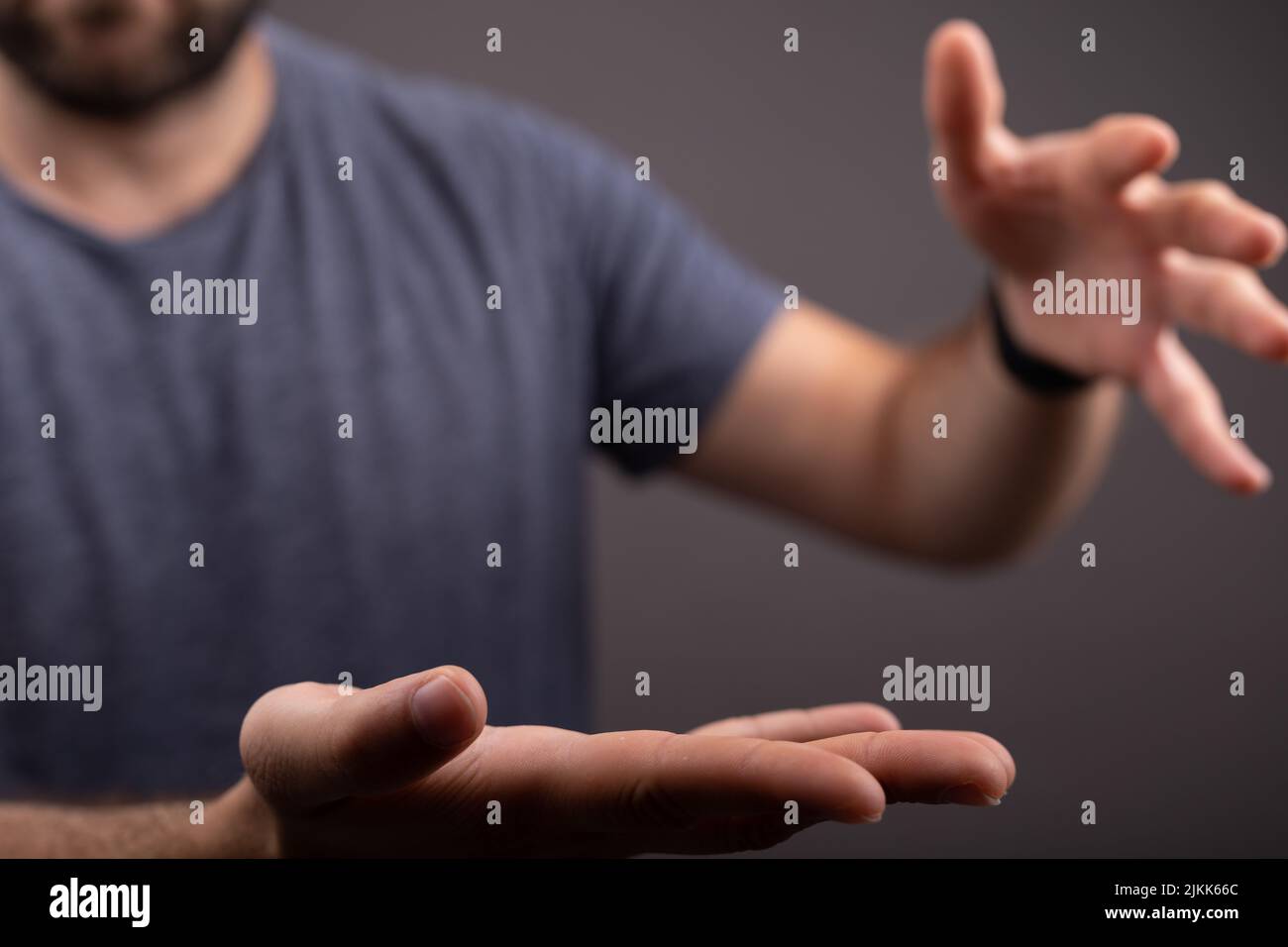 A closeup of a male showing an outstretched hand with an open palm ...