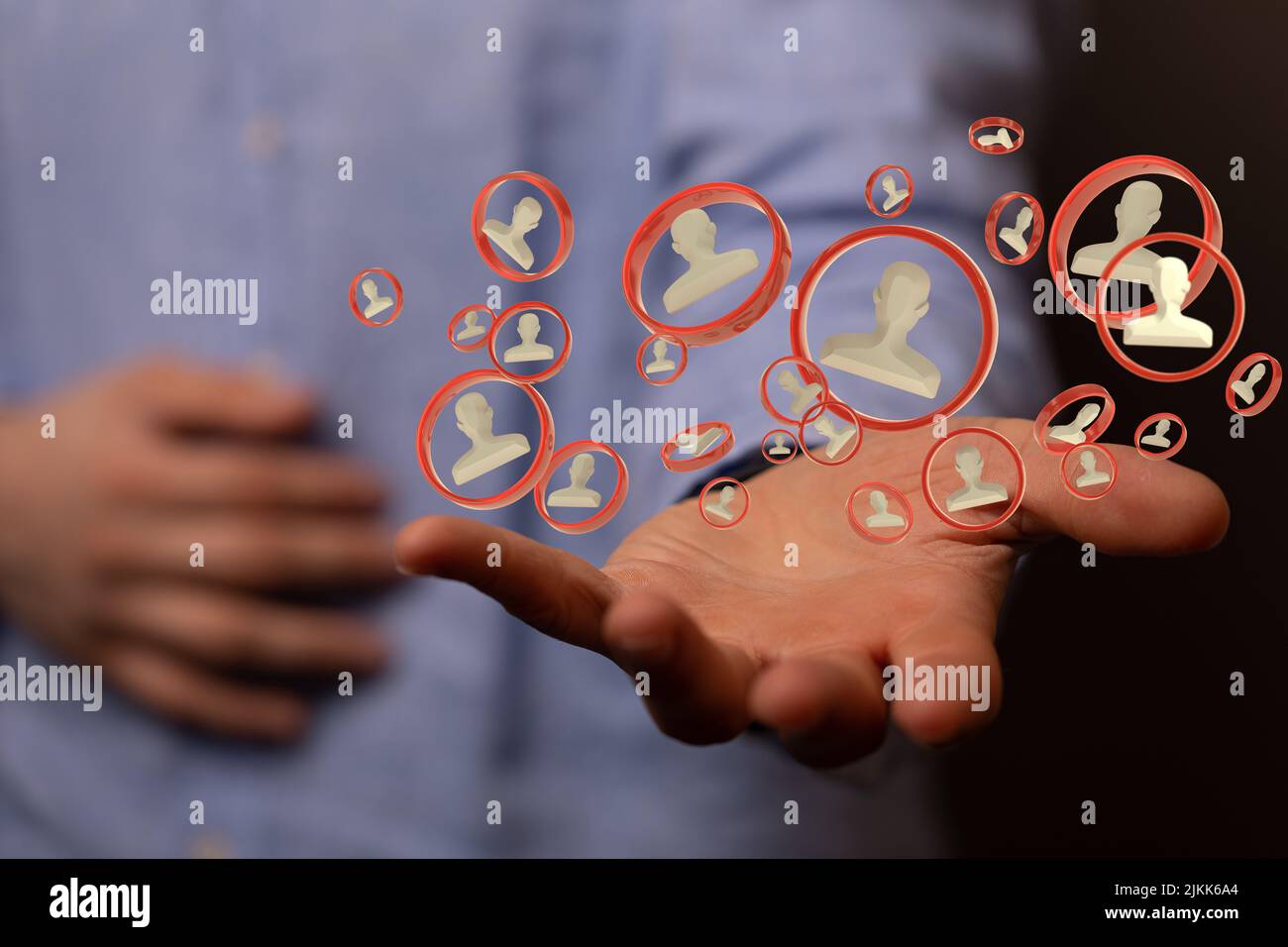 A 3D rendering of people icons hovering over a man's hand Stock Photo ...