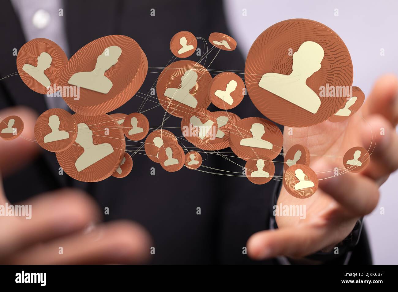 A group of 3D rendered people icons hovering between a man's hands ...