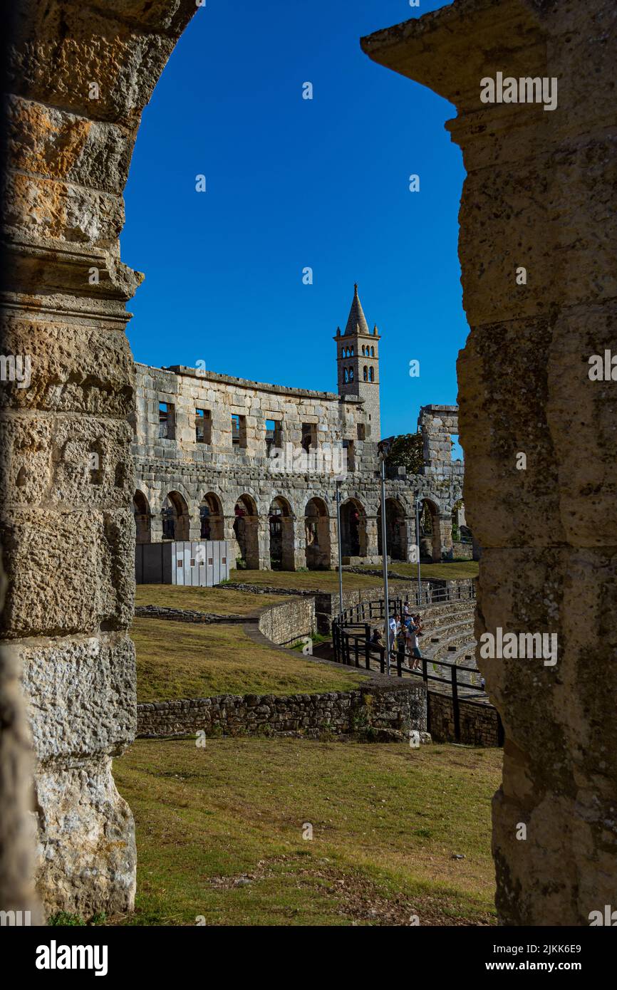 A Vertical shot of the beautiful architecture of Pula Arena with a ...