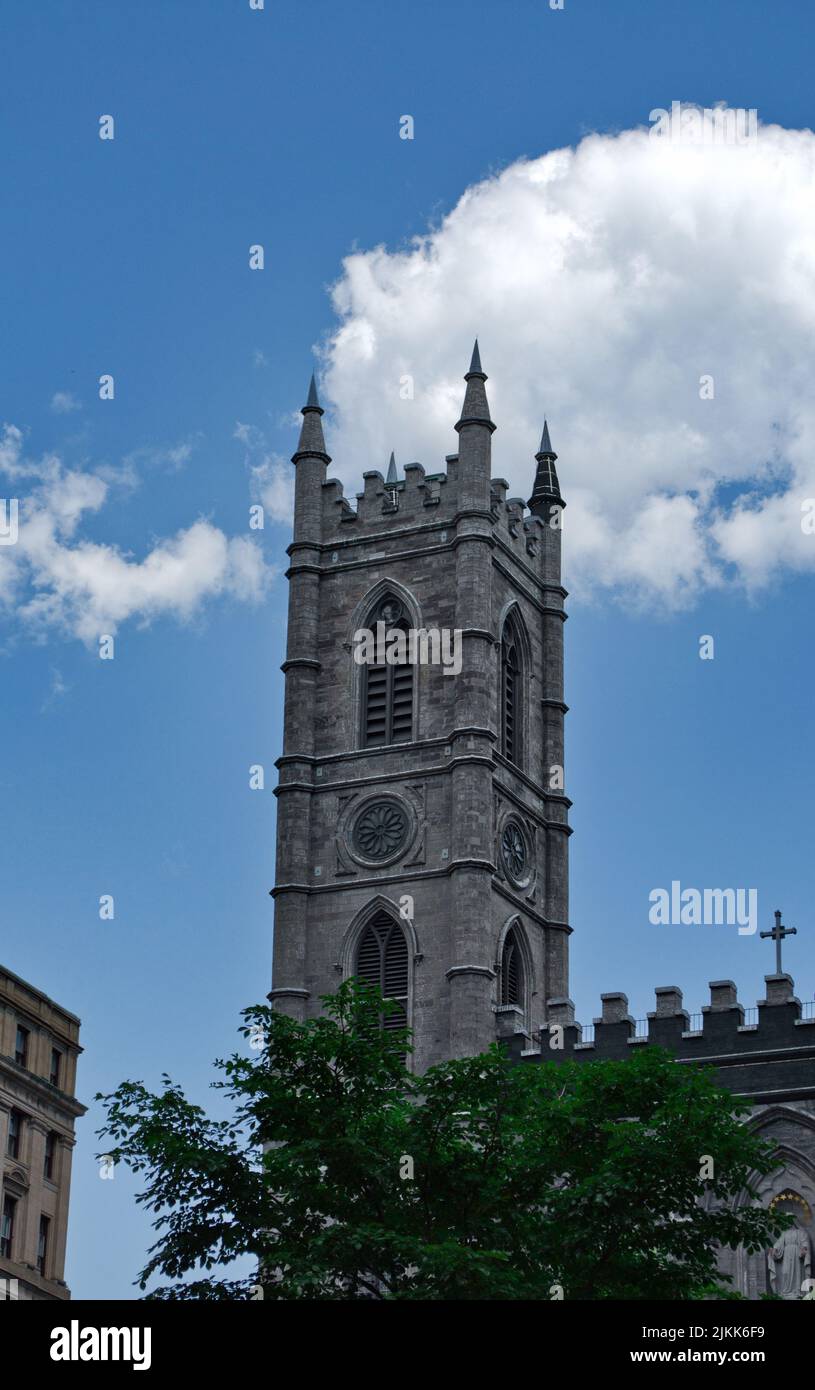 A vertical shot of the beautiful Notre-Dame Basilica of Montreal in ...
