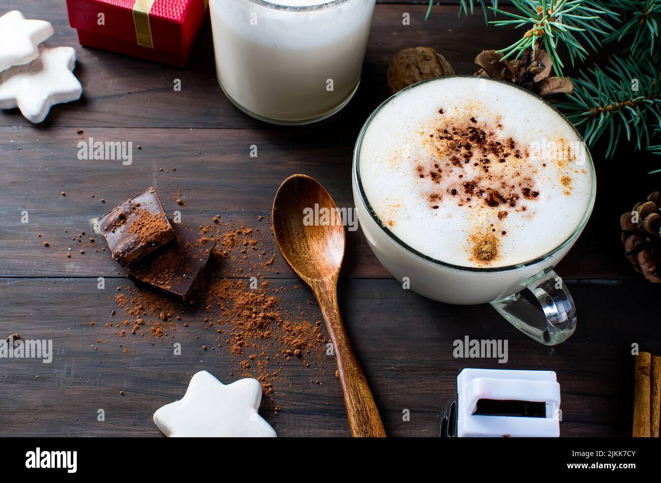 Two cups of hot cocoa or hot coffee latte with cinnamon, fir tree and ...