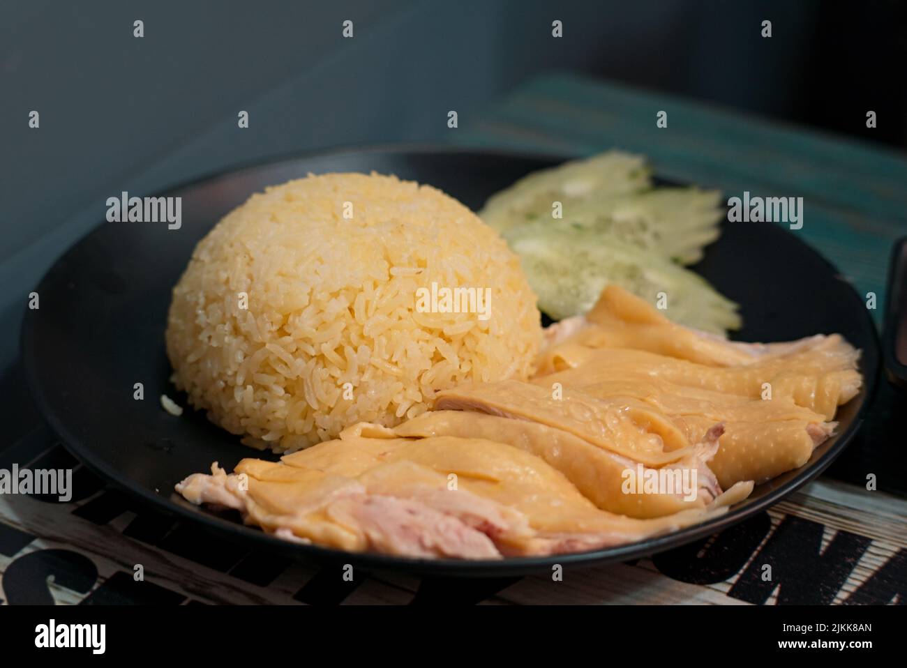 A closeup of a delicious Hainanese chicken rice with poached chicken ...