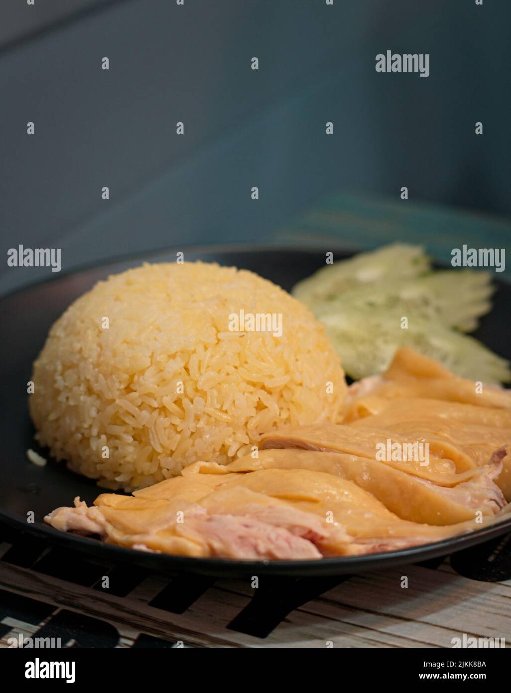 A delicious Hainanese chicken rice with poached chicken and seasoned ...