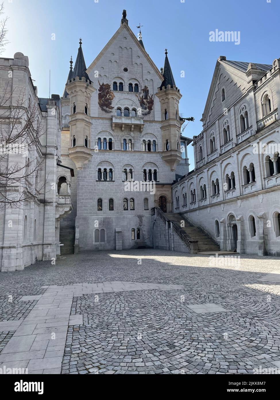 A vertical shot of a old beautiful castle paved square in front Stock ...