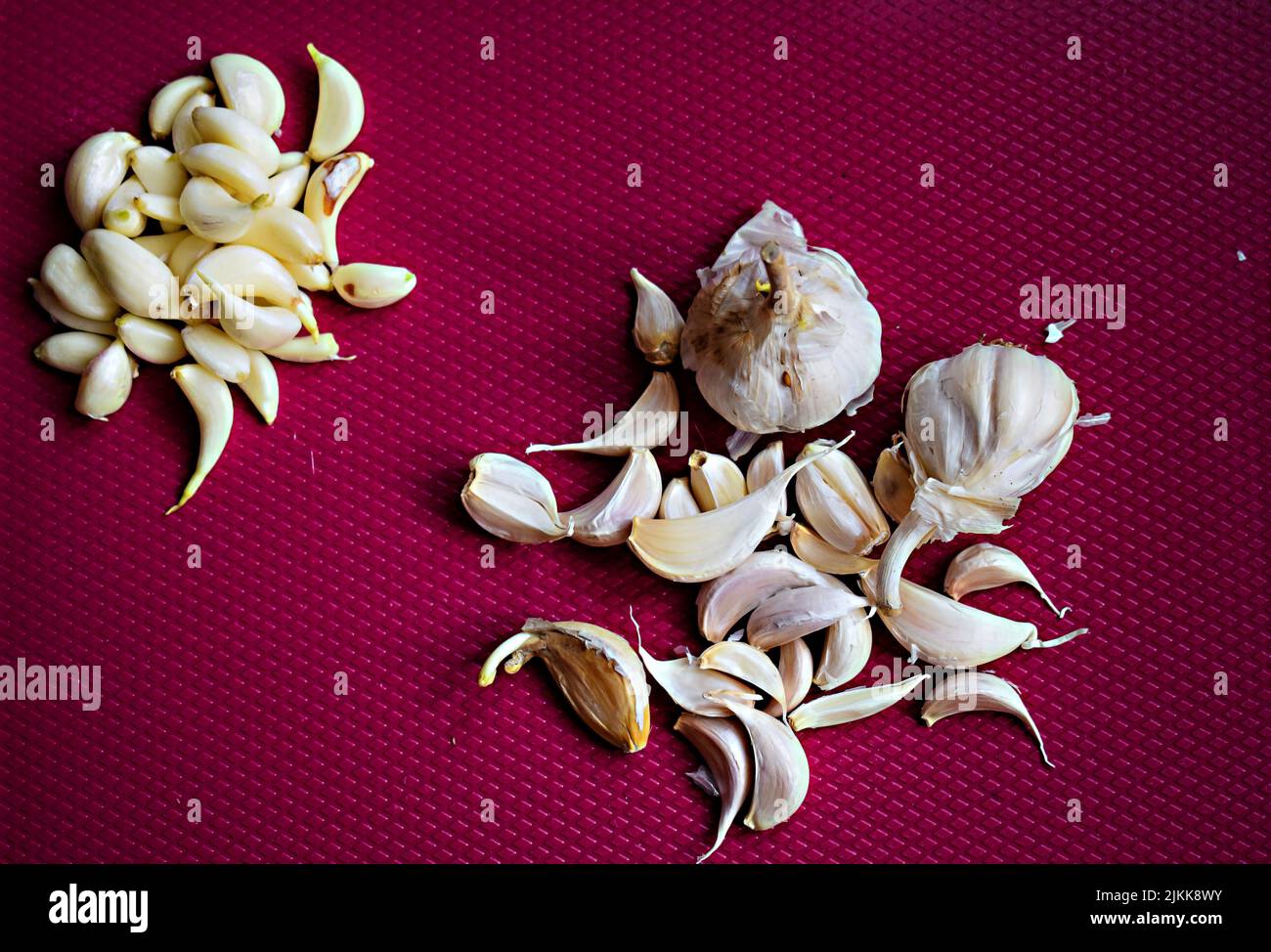 Stock photo of bunch of peeled garlic cloves and unpeeled garlic cloves ...
