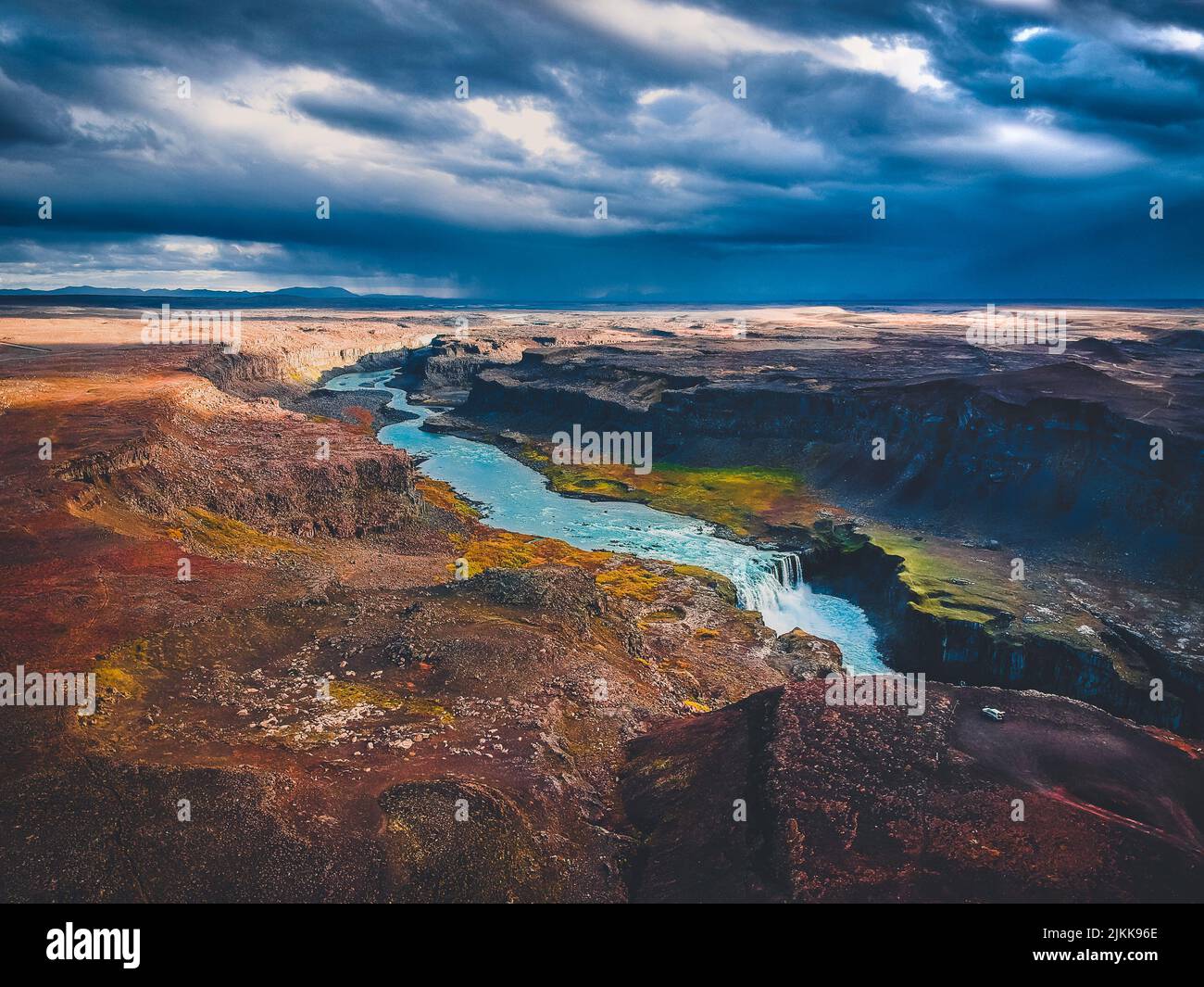 An aerial view of a beautiful river flowing through the cliffs of ...