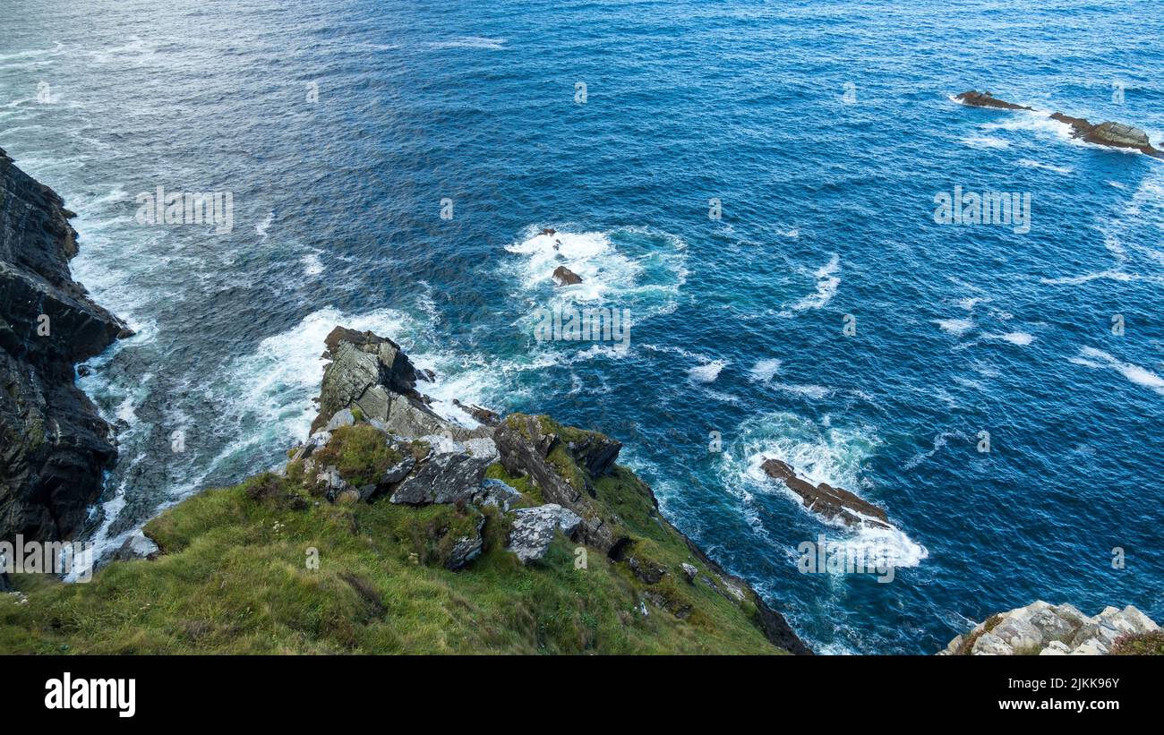 An aerial view of calm clear water and greenery-covered hills in ...