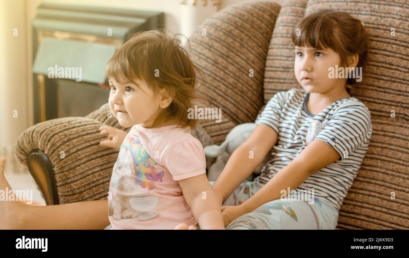A beautiful shot of little sisters watching TV together Stock Photo - Alamy