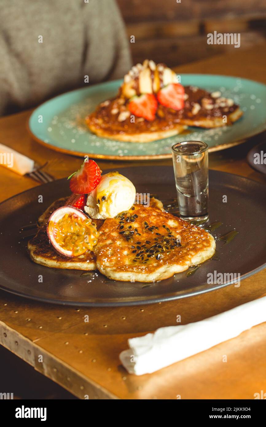 A vertical selective shot of a pancake with a boiled egg and passion ...
