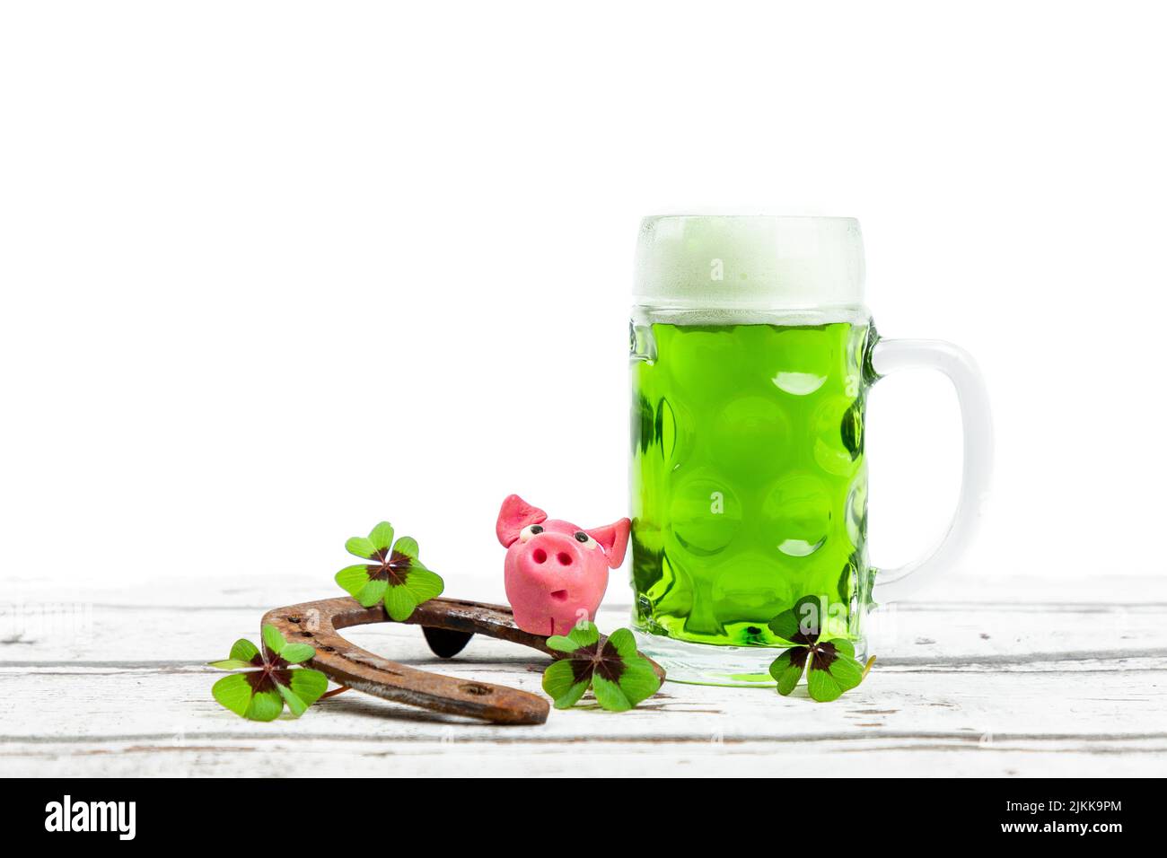 green beer glass with pink pig, shamrock and horseshoe for st patricks ...