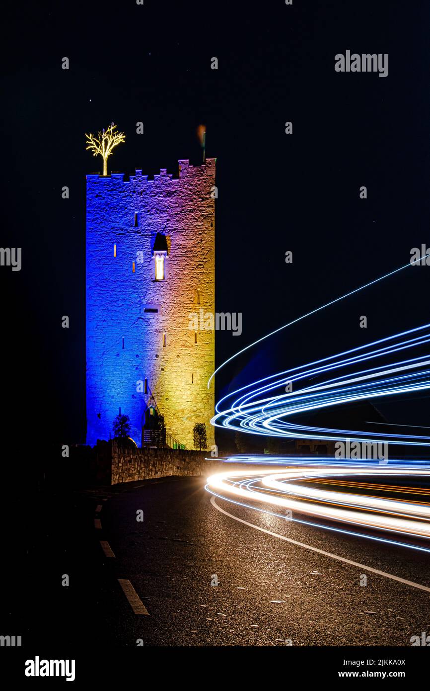A Vertical night shot of Rochester Castle with colorful lights on a ...