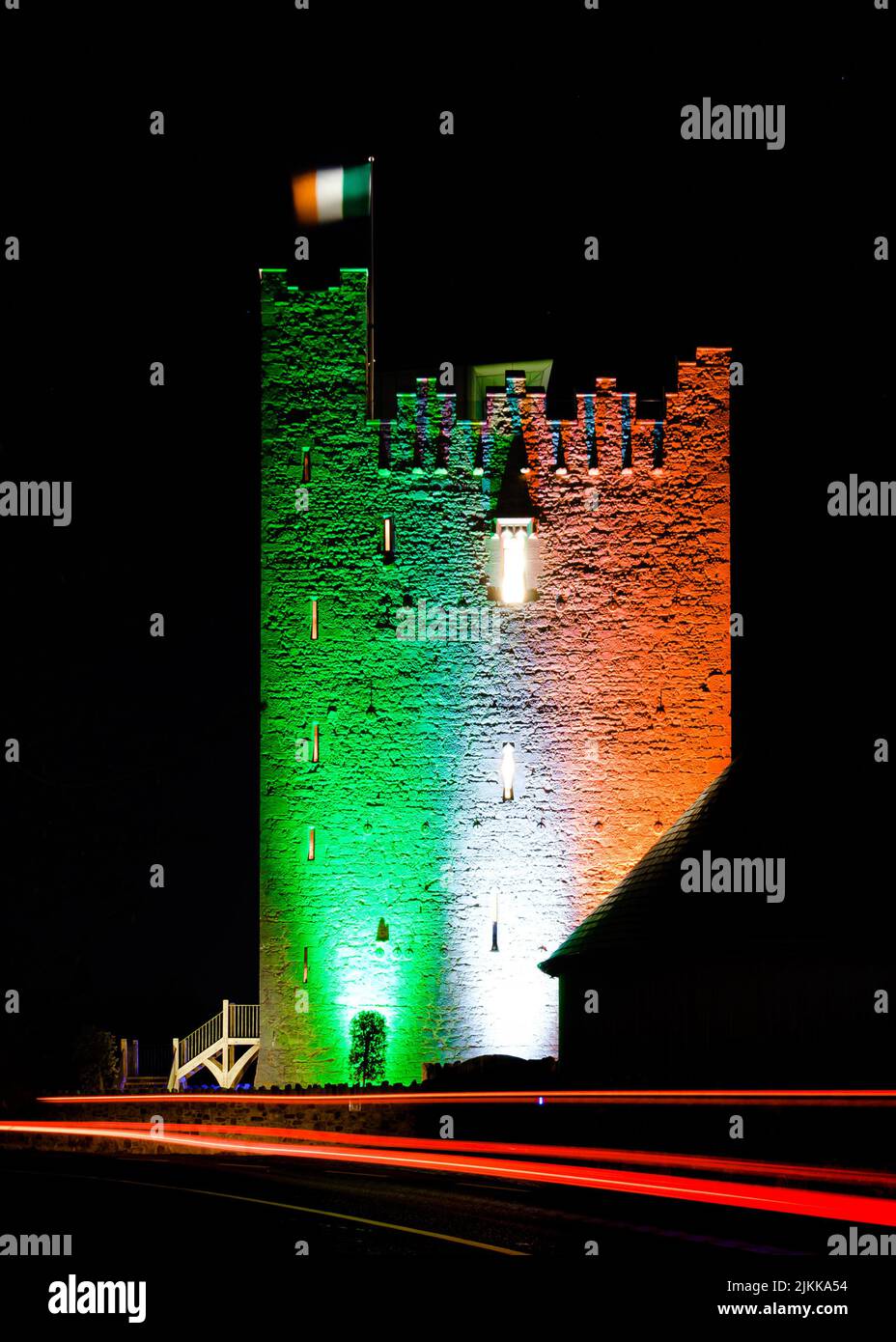 A vertical night shot of Rochester Castle with colorful lights on a ...