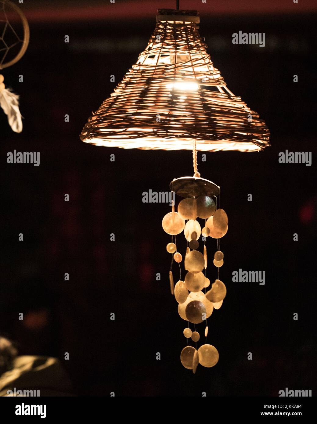 A closeup shot of cane light with golden coins decoration hanging in it ...
