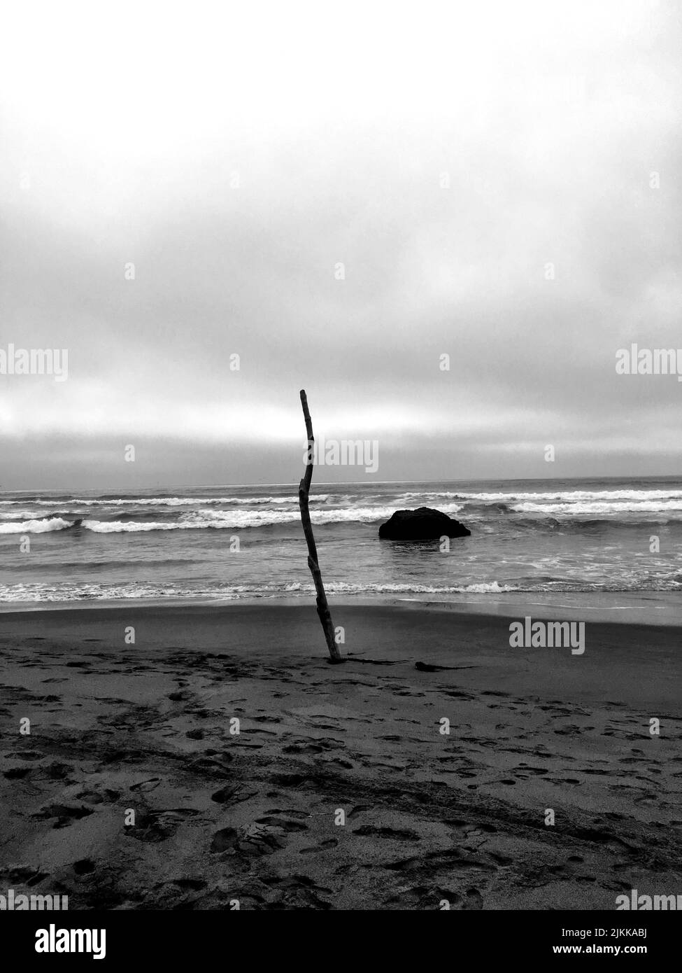 A grayscale of a sandy beach on a cloudy day Stock Photo - Alamy