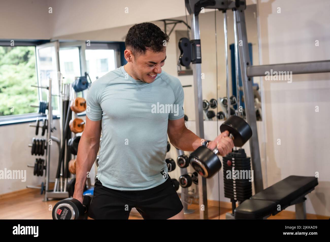 Athlete man in the gym doing weights Stock Photo - Alamy