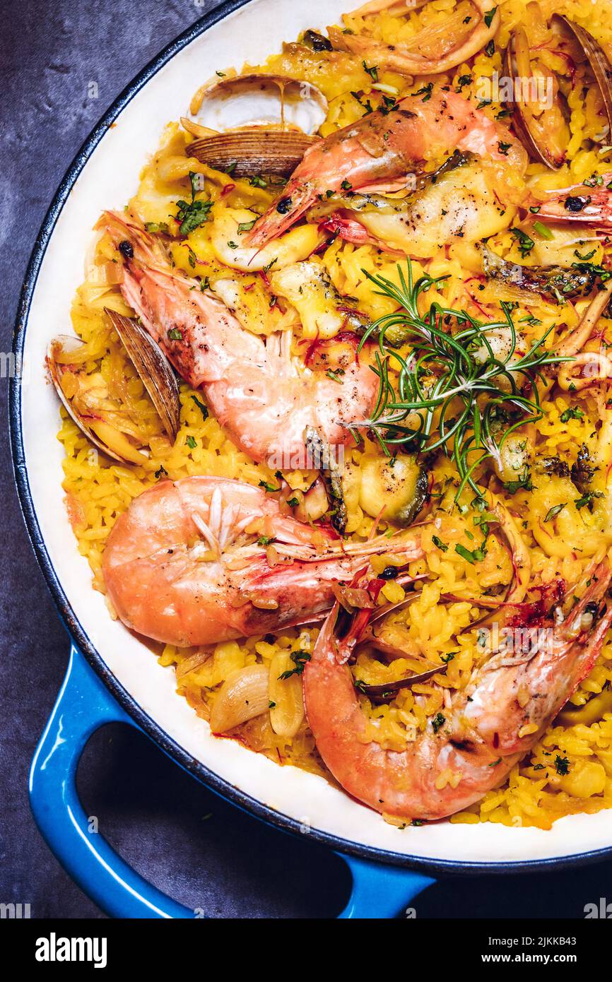 A vertical top shot of Saffron Risotto with shrimps, rice and other ...