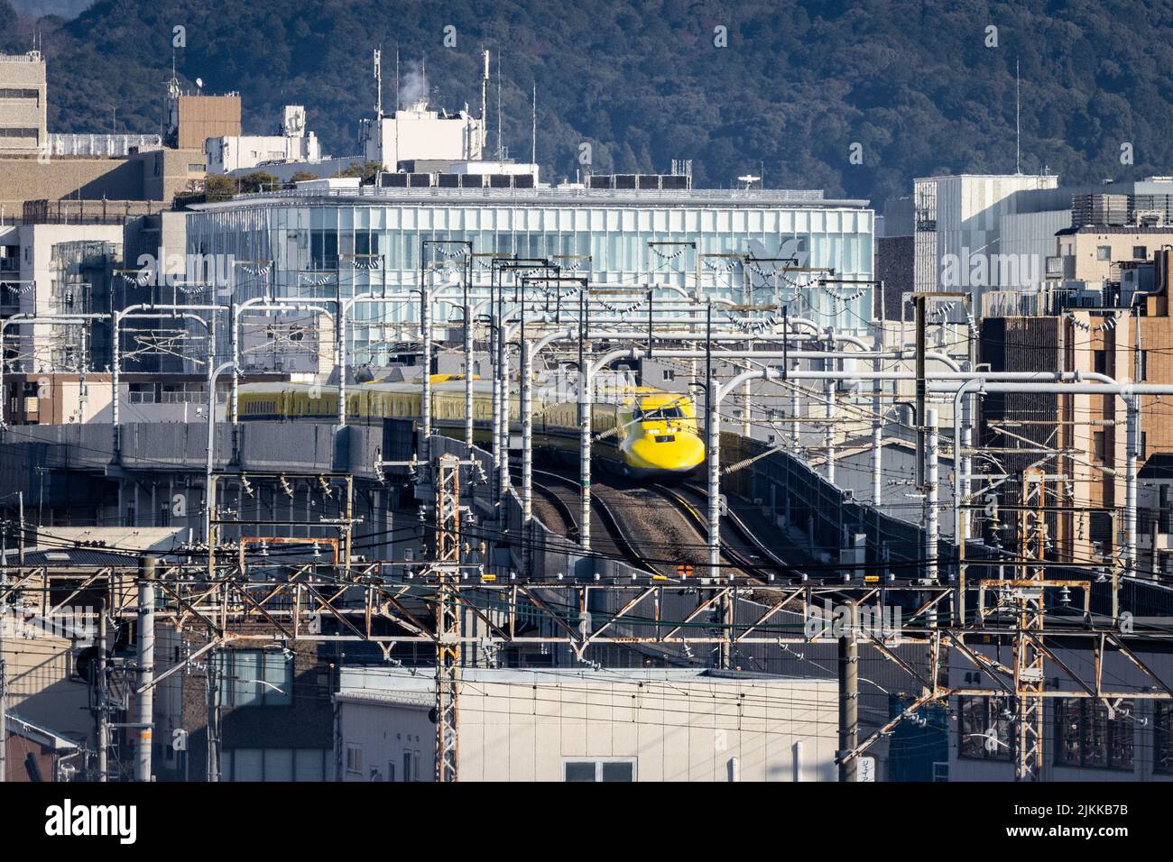 A motion view of yellow bullet train Shinkansen in background of ...