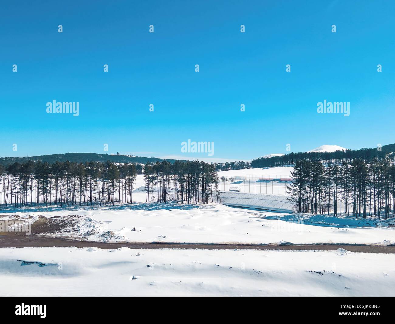 An aerial shot of beautiful snowy mountains in a winter cold daytime ...