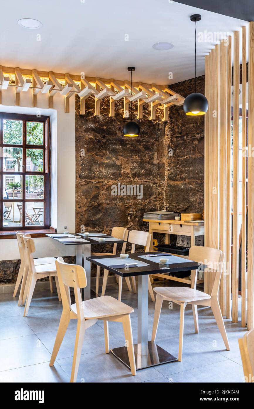 A vertical shot of an interior of a restaurant with contemporary design ...