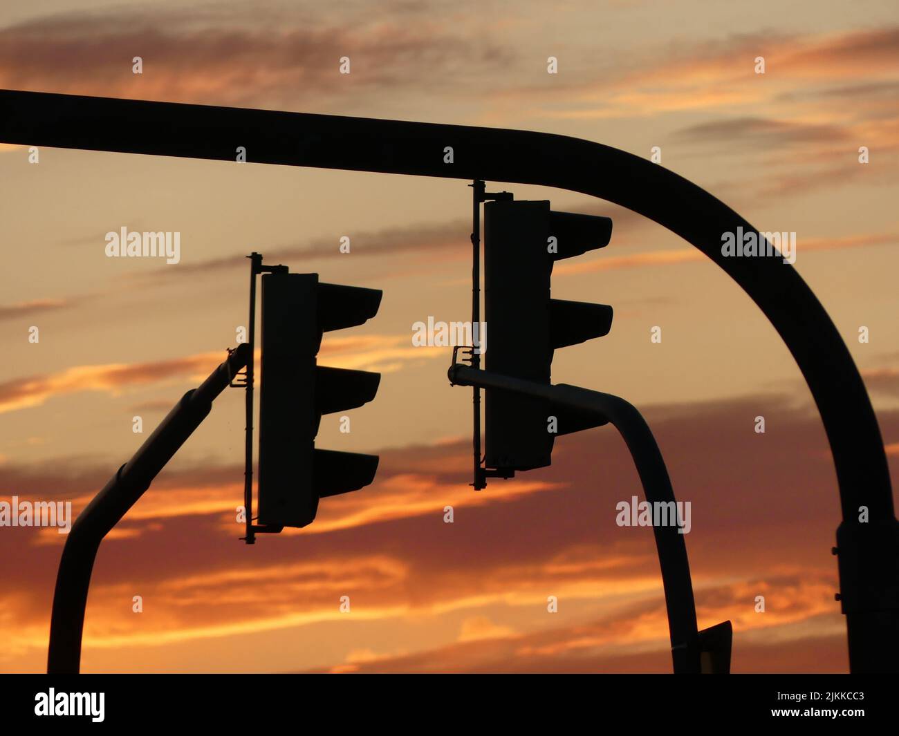 A silhouette of the traffic lights on a freeway against the cloudy ...