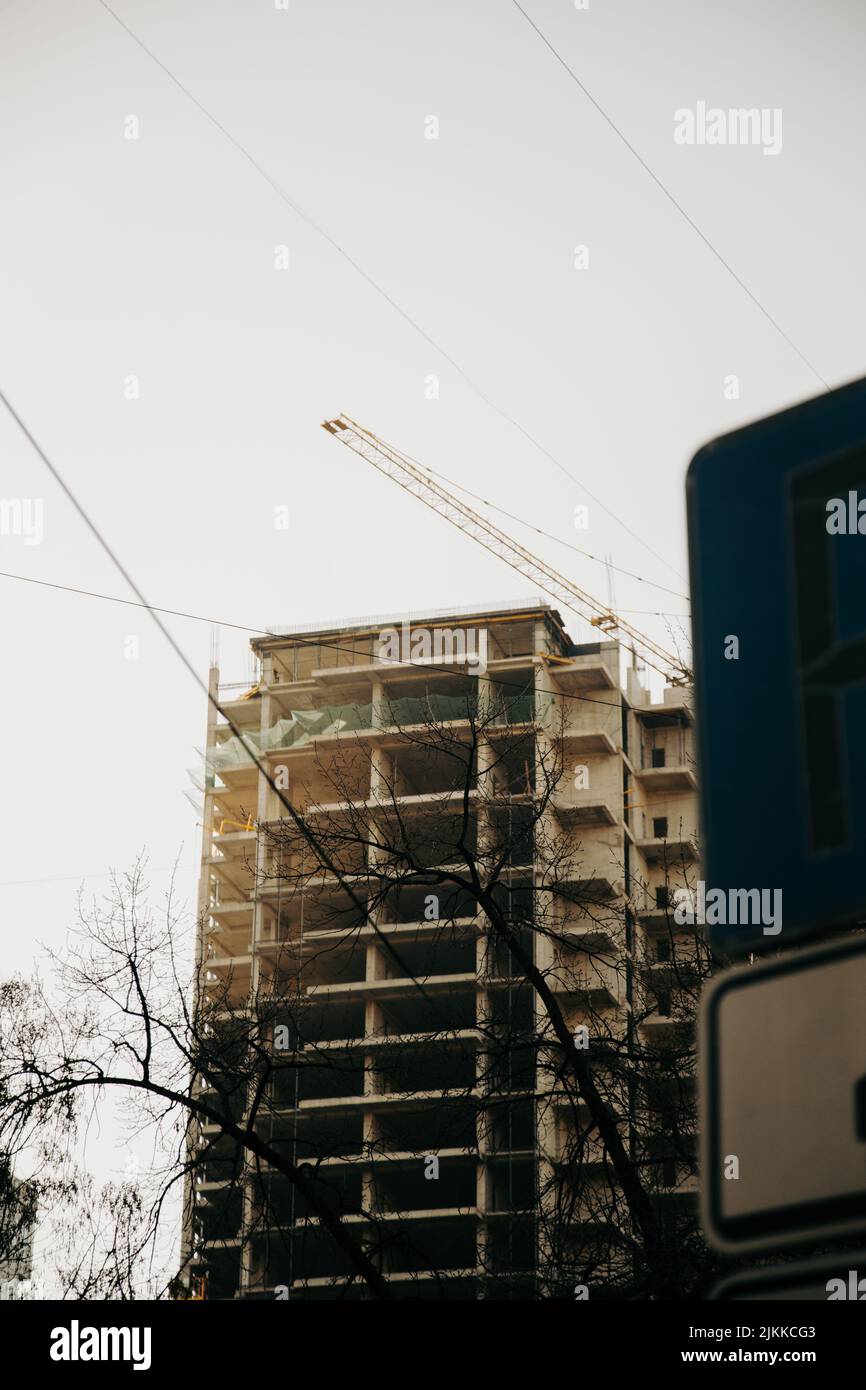 A scenic shot of a building under the construction surrounded by trees ...