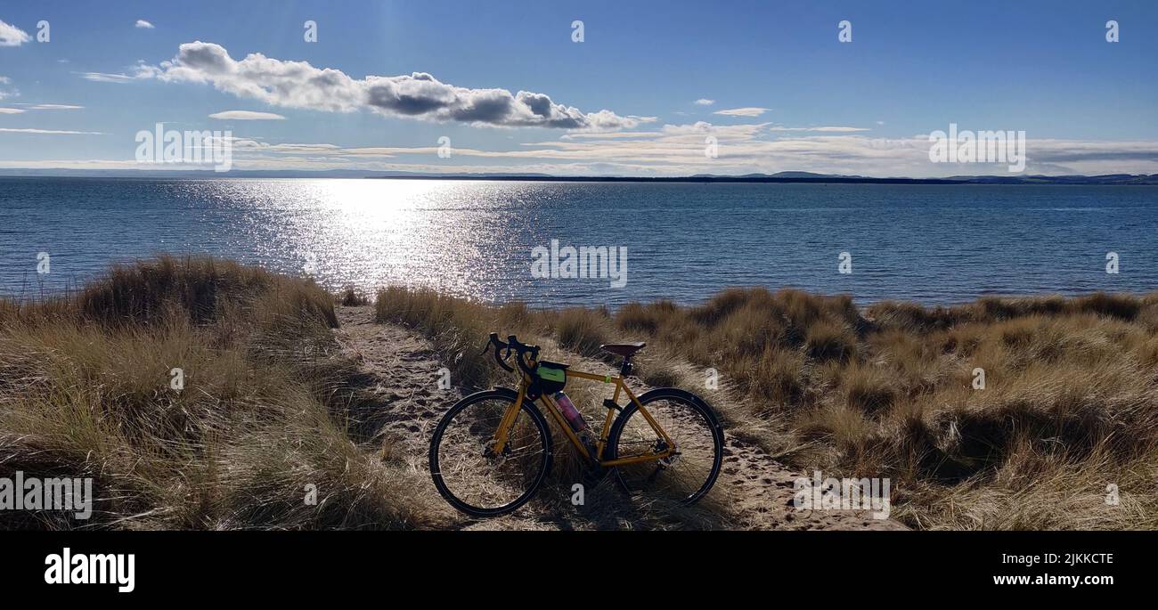 A beautiful seascape view with a yellow bicycle parked on a beach Stock ...