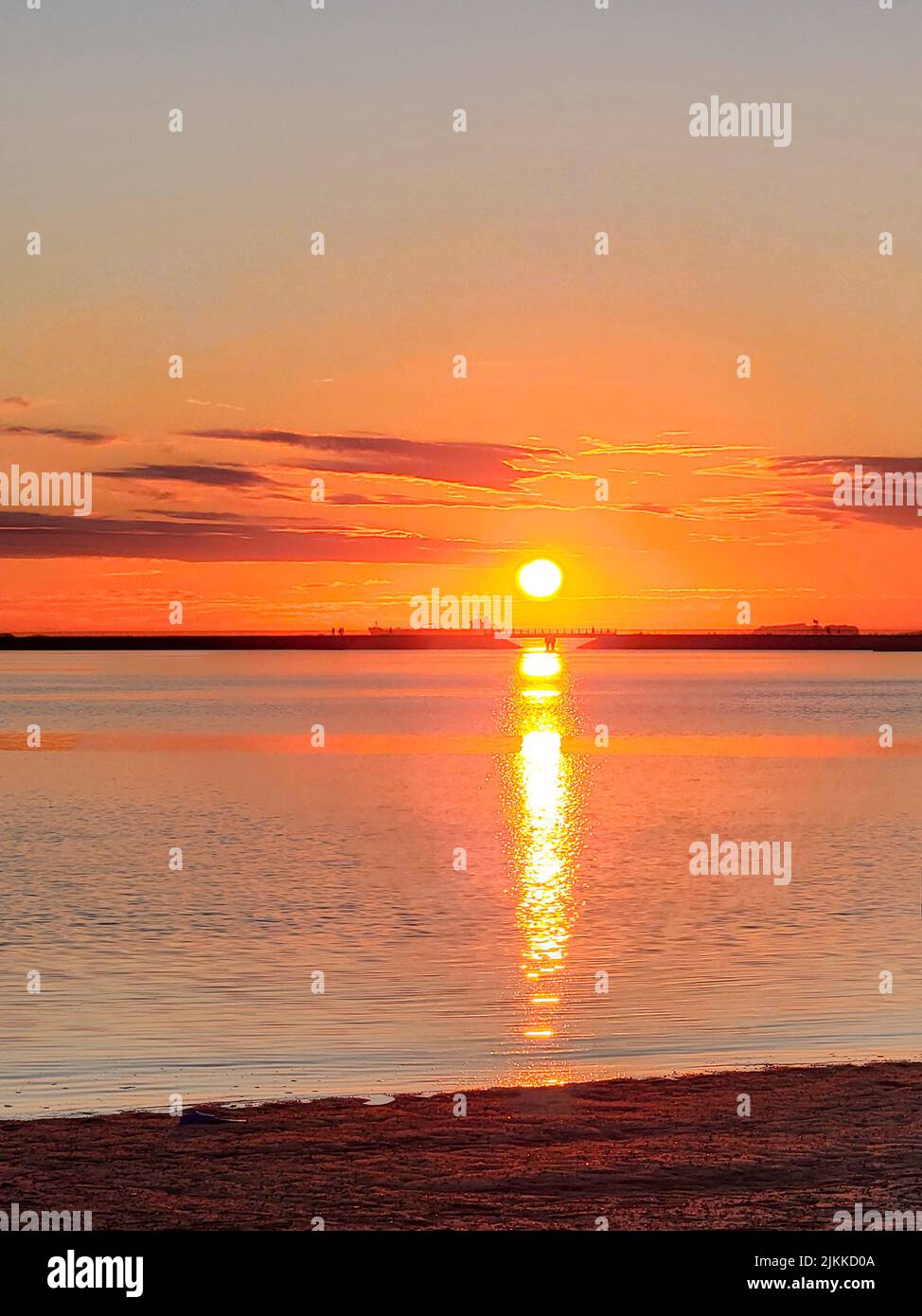 a vertical shot of the ocean during sunrise from the beach Stock Photo ...