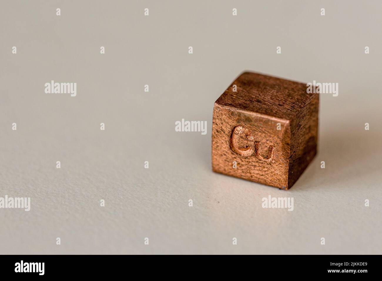 Copper cube with element name Cu on it on cream background Stock Photo ...